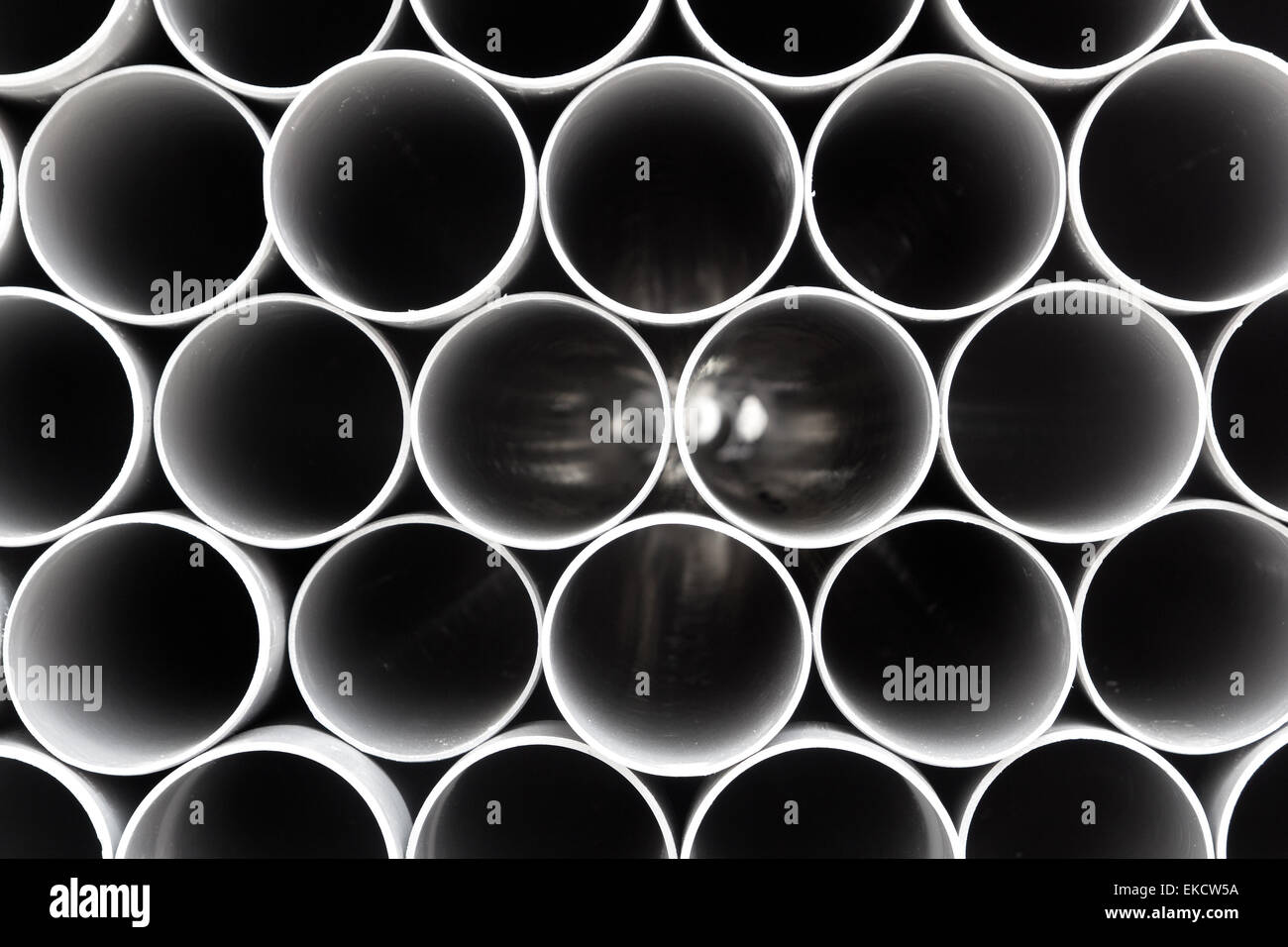 gray PVC tubes plastic pipes stacked in rows Stock Photo - Alamy