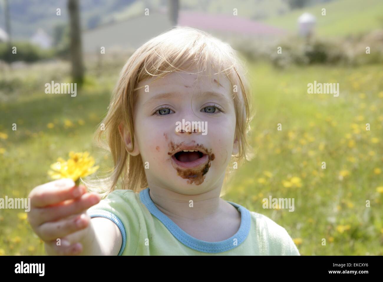 Adorable little girl eating chocolate Stock Photo - Alamy