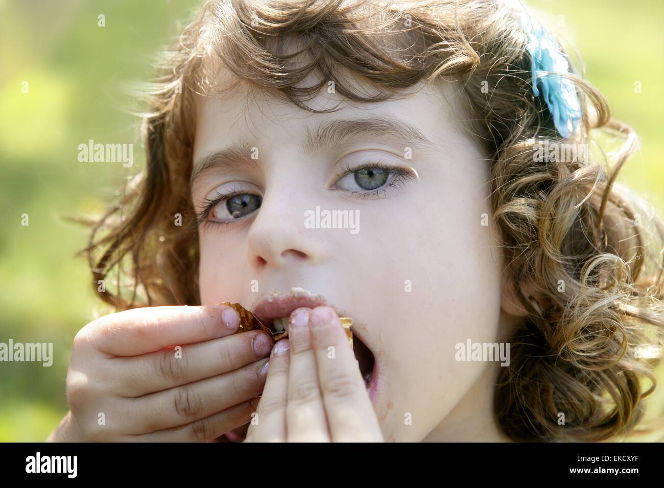 Adorable little girl eating chocolate Stock Photo - Alamy