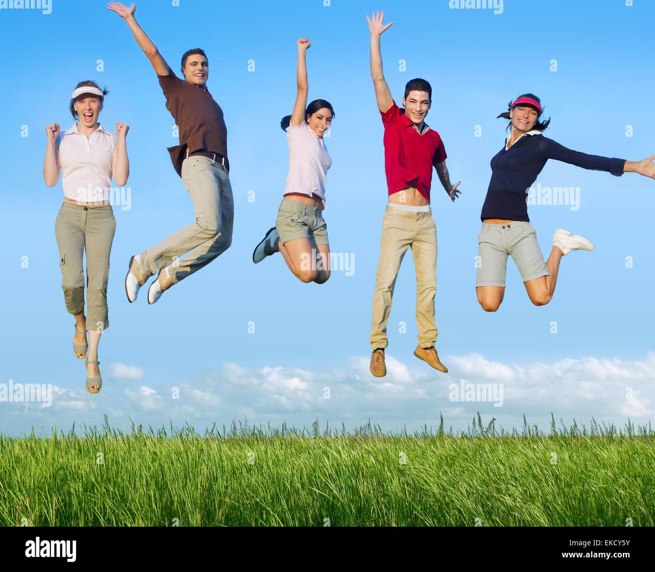 Jumping young people happy group in meadow Stock Photo - Alamy