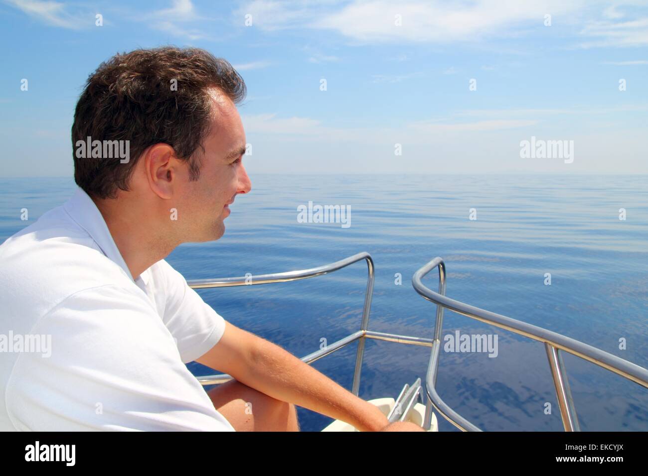 Sailor man sailing boat blue calm ocean water Stock Photo - Alamy