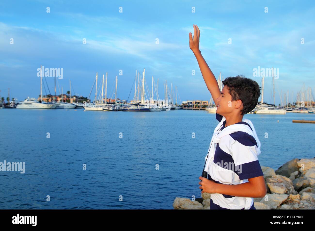farewell boy rising hand up goodbye in boats marina Stock Photo - Alamy