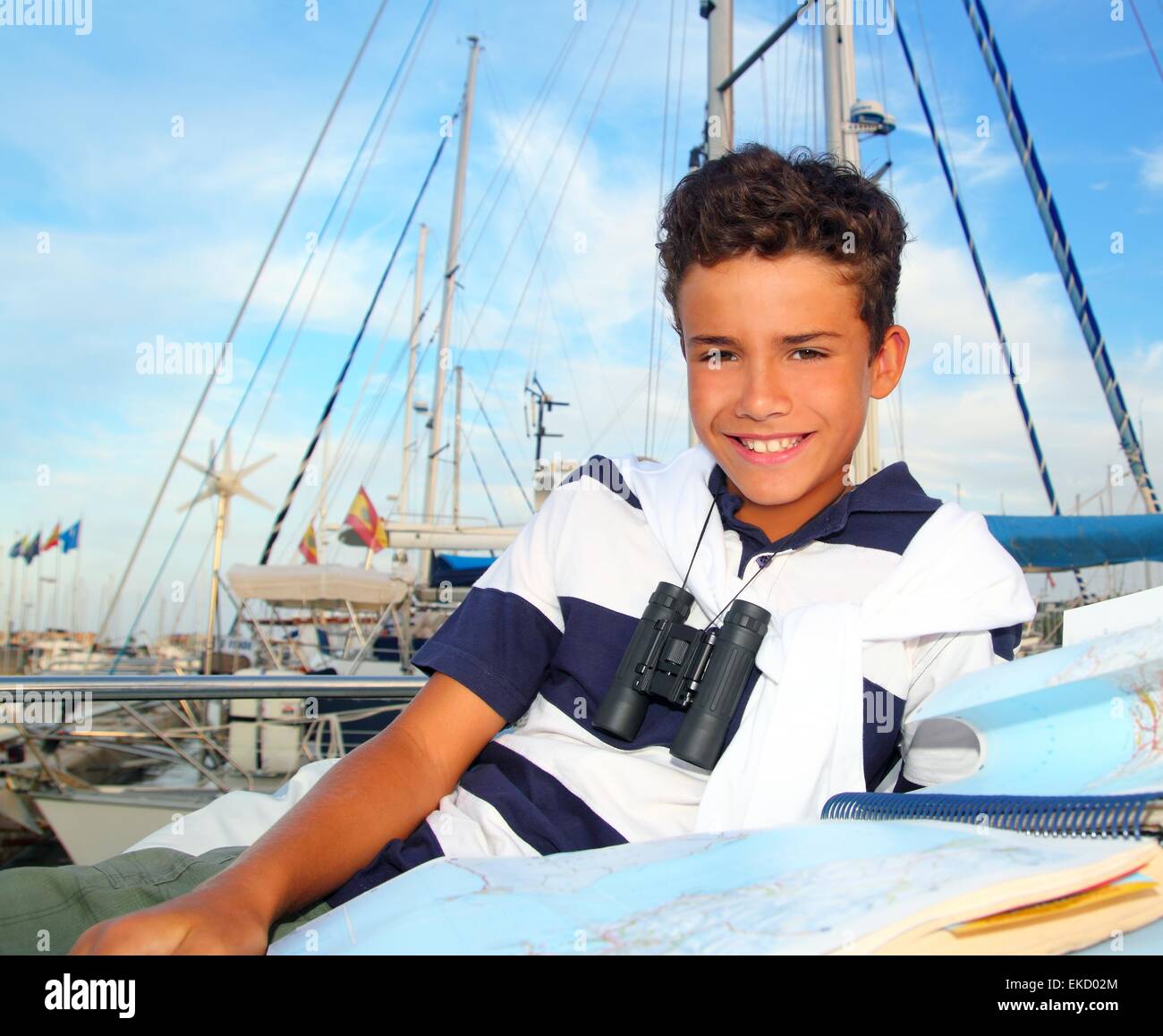 boy teen sailor laying on marina boat chart map Stock Photo - Alamy