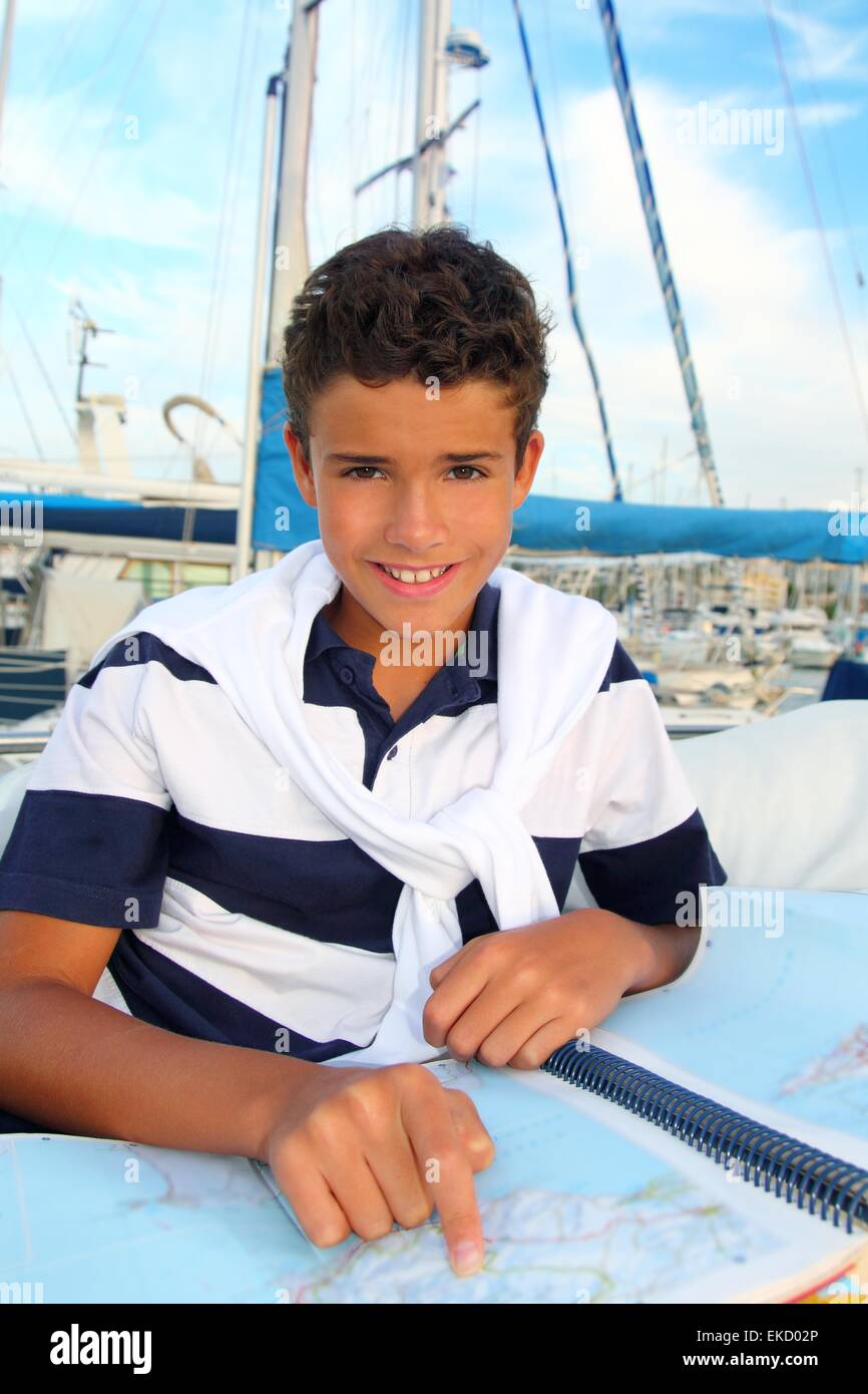 boy teen sailorsitting on marina boat chart map Stock Photo - Alamy