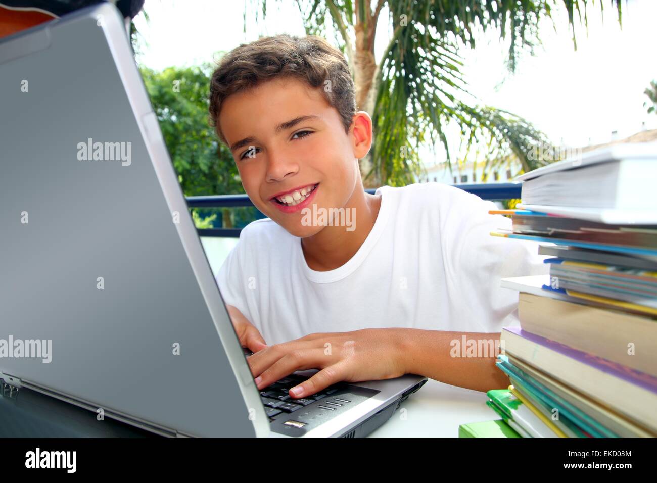 Happy teenager student boy working laptop Stock Photo - Alamy