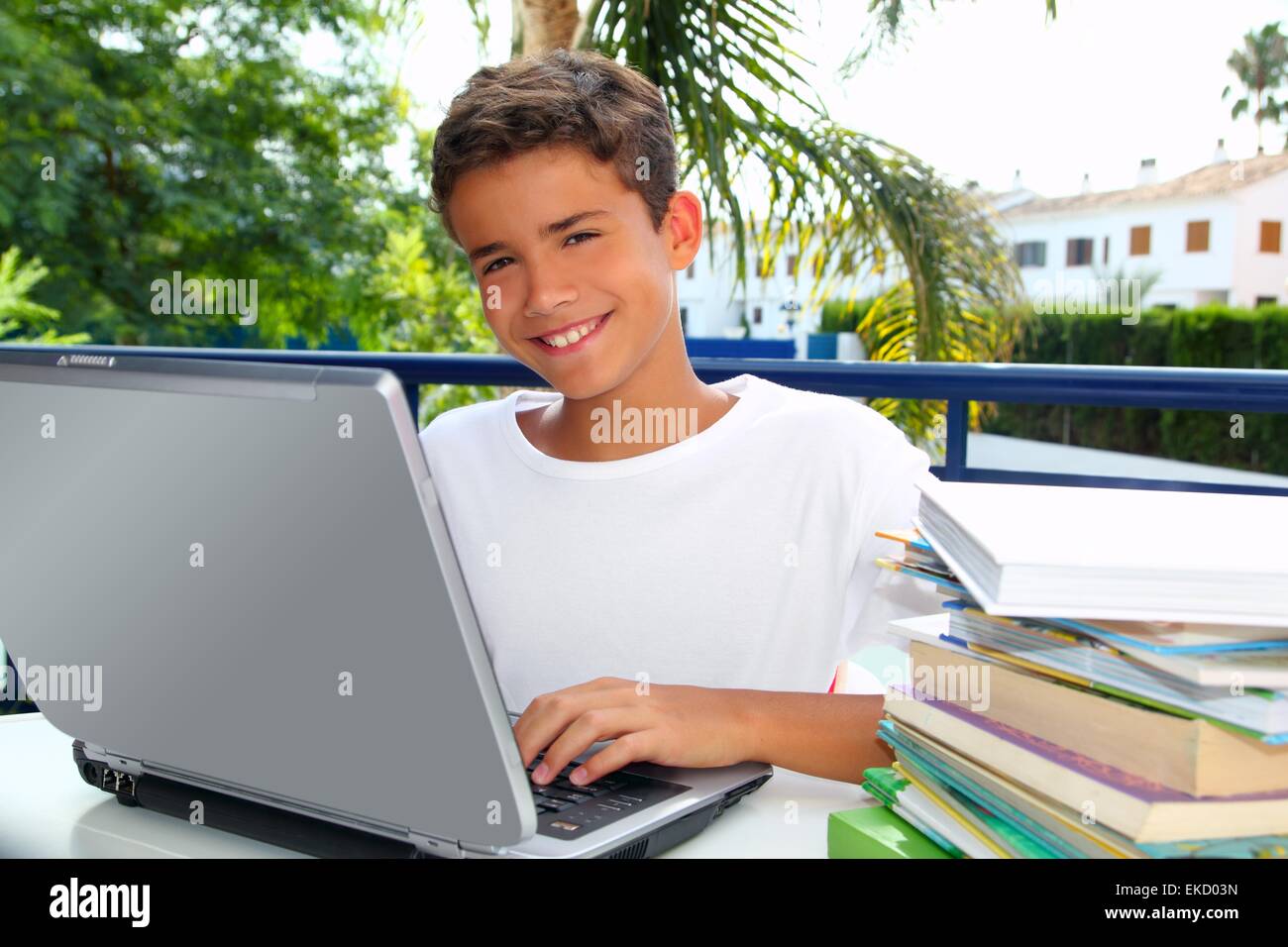 Happy teenager student boy working laptop Stock Photo - Alamy