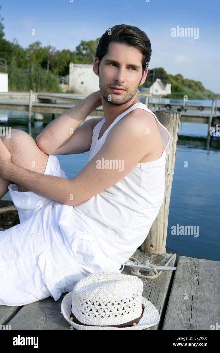 Mediterranean young man relaxed on wood pier Stock Photo - Alamy
