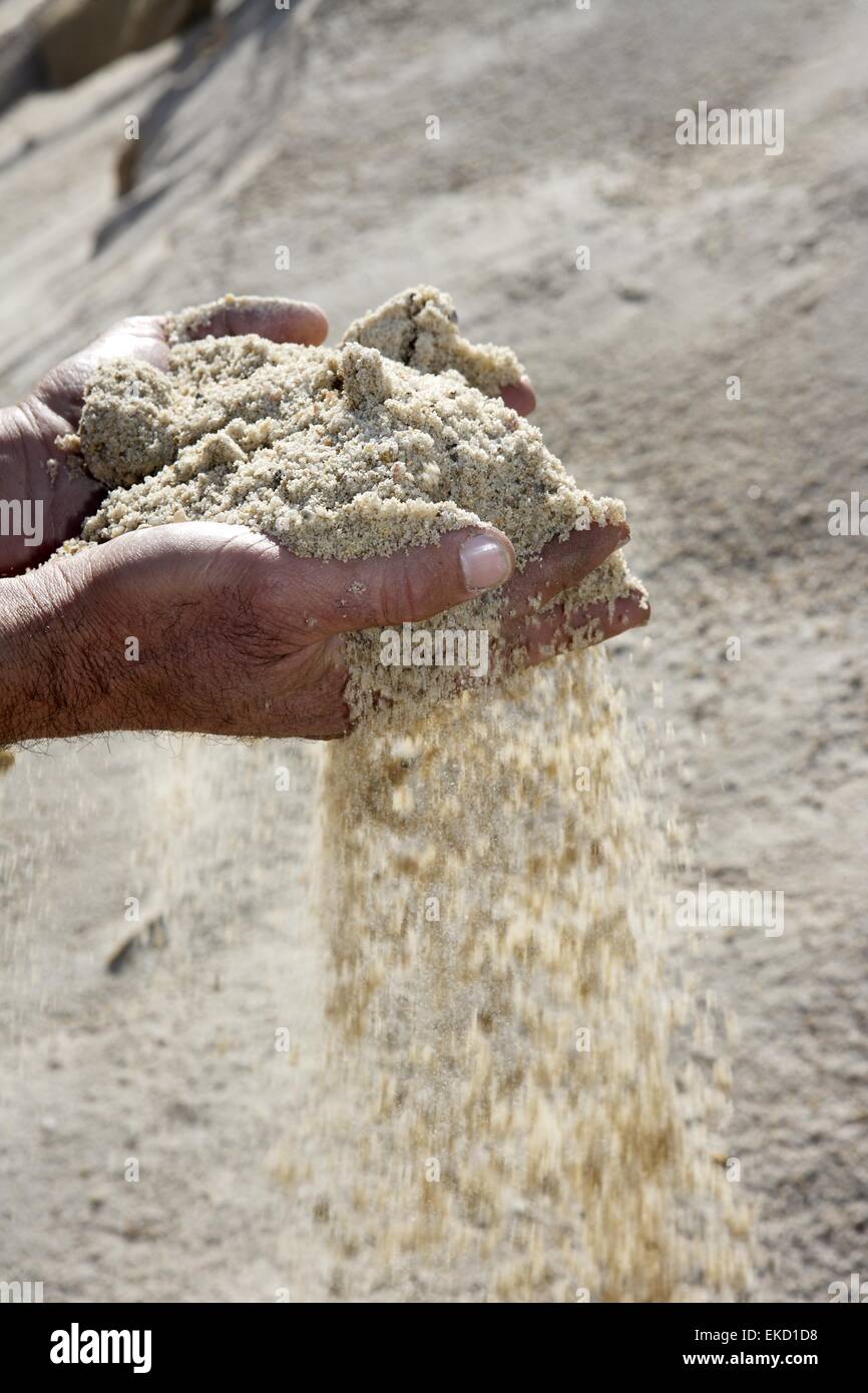 gravel sand in man hands in quarry background Stock Photo - Alamy
