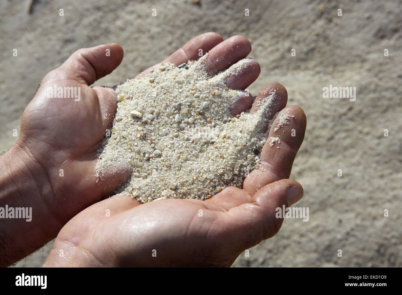 gravel sand in man hands in quarry background Stock Photo - Alamy