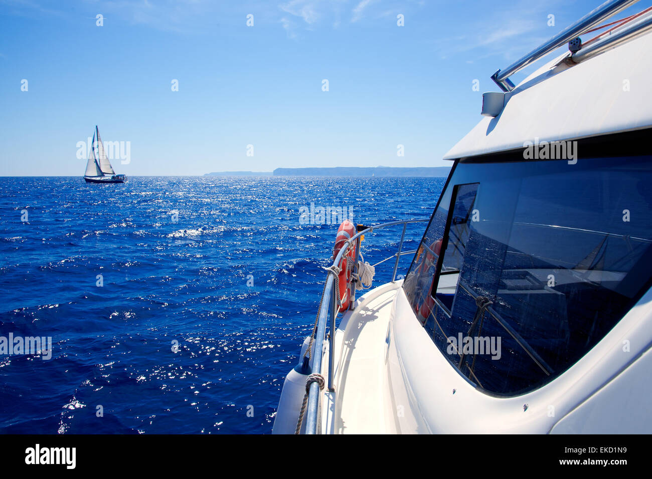 boat side view of blue ocean with sailboat Stock Photo - Alamy