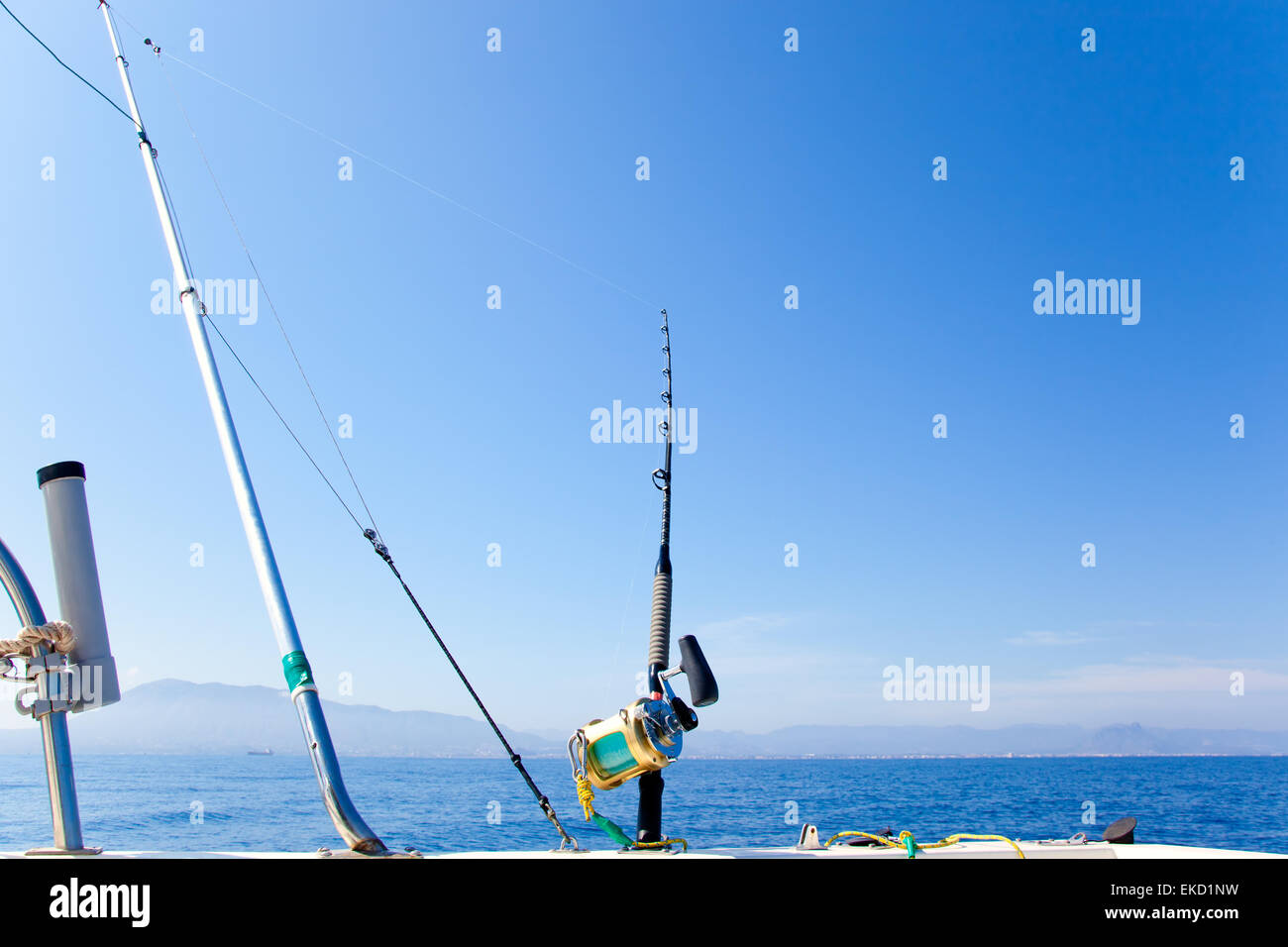fishing boat trolling with outrigger gear Stock Photo - Alamy