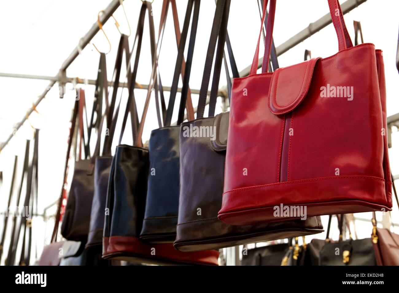 bags rows in retail shop handbags leather red Stock Photo - Alamy