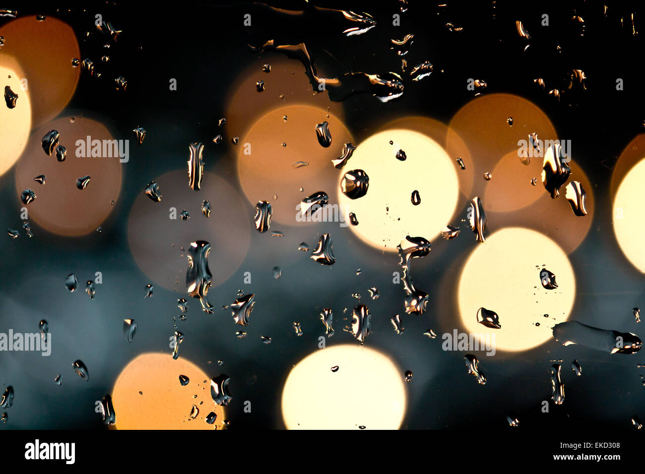 Drops of rain on window with bokeh lights abstract Stock Photo - Alamy