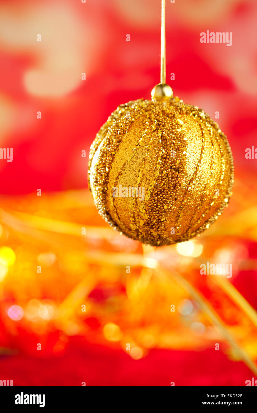 Christmas card of golden bauble and red blur Stock Photo - Alamy