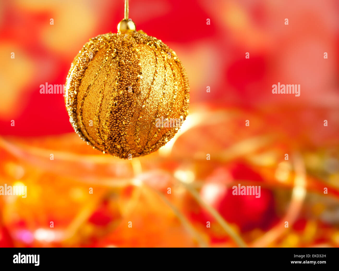 Christmas card of golden bauble and red blur Stock Photo - Alamy