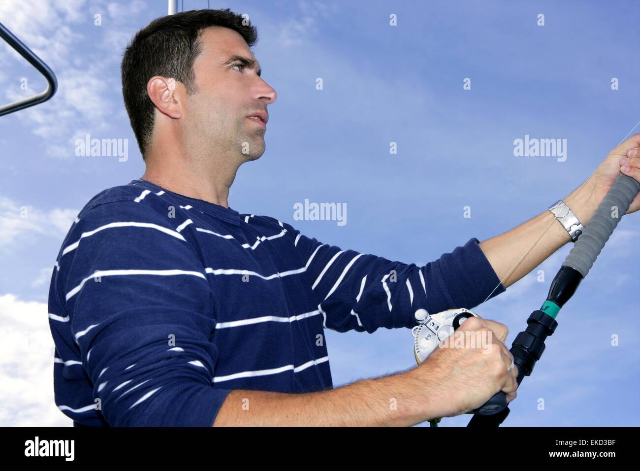 Angler fisherman trolling rod and reel fishing Stock Photo - Alamy