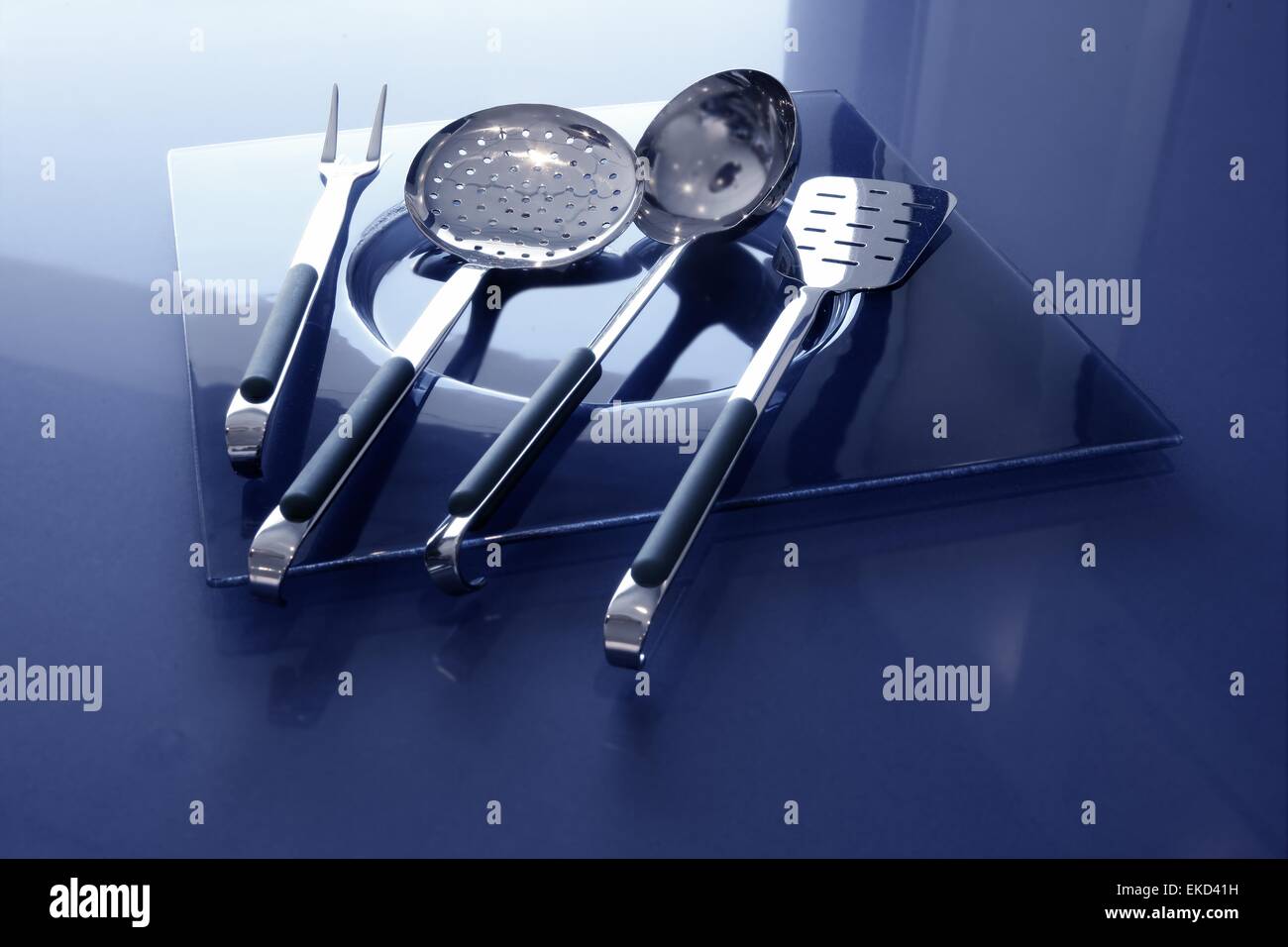 kitchenware kitchen utensils blue and stainless steel Stock Photo - Alamy