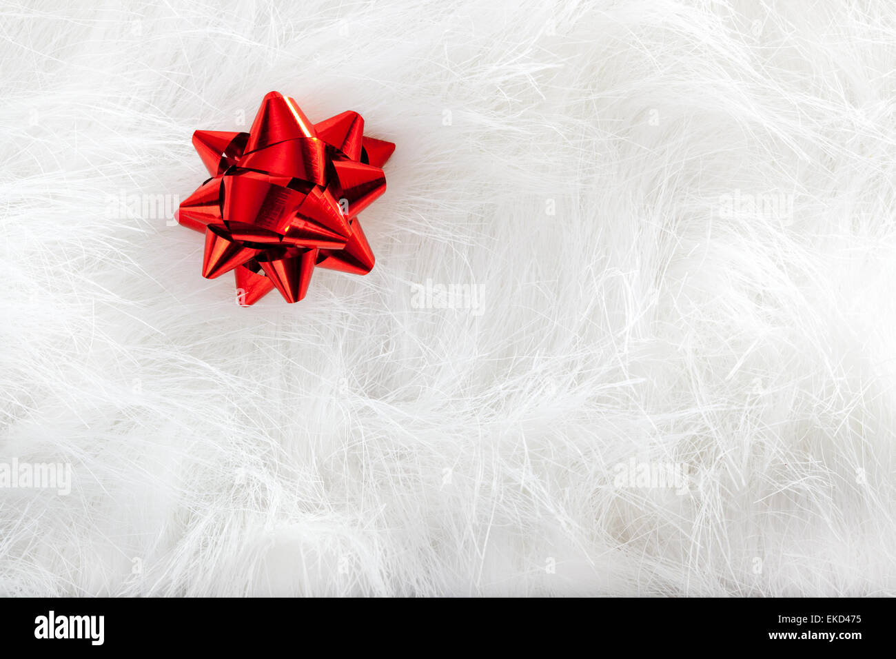 Christmas red ribbon look over white fur Stock Photo - Alamy