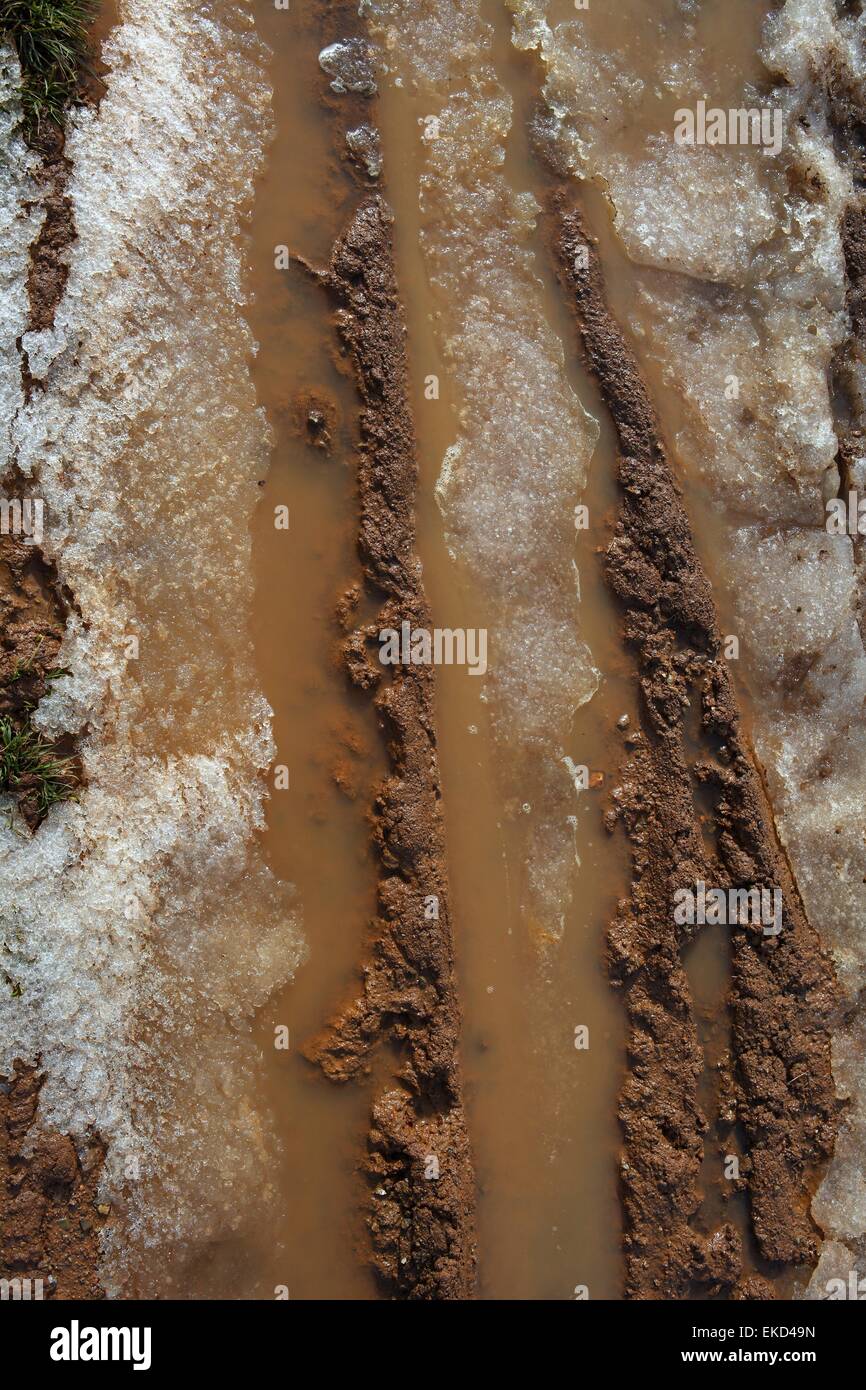 ice on mud red clay soil road with tyres lines Stock Photo - Alamy