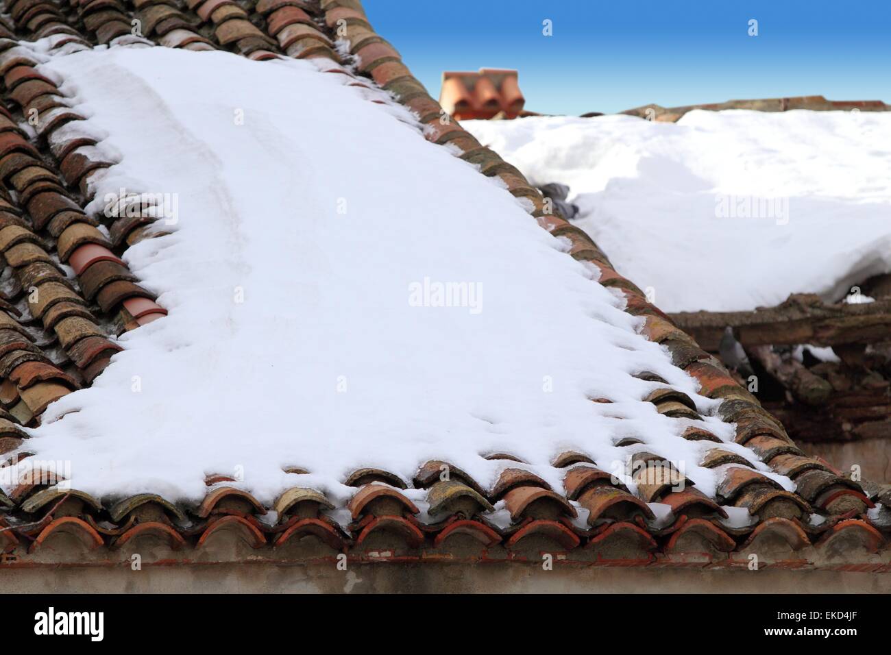 aged clay roof tiles snowed under winter snow Stock Photo - Alamy