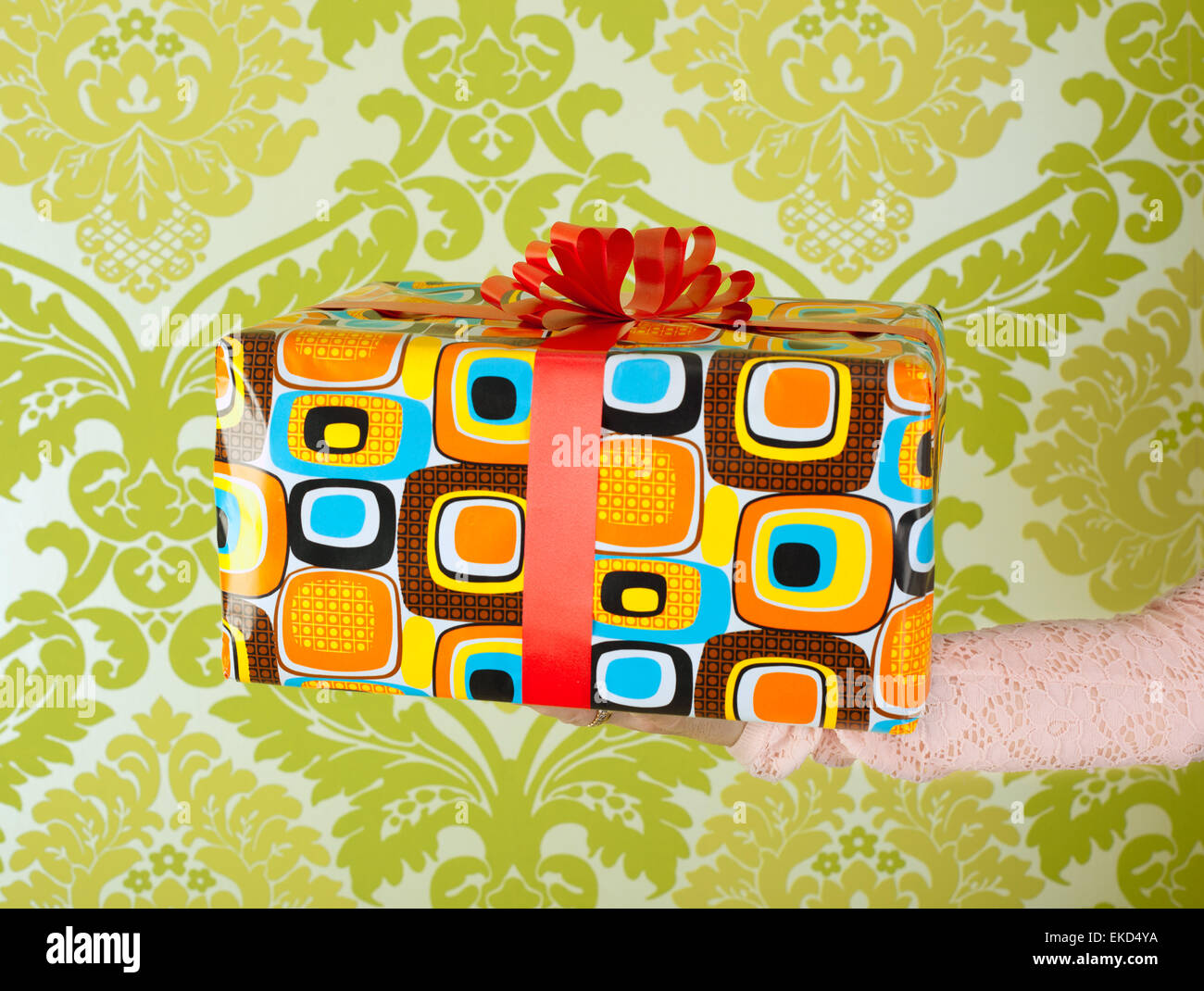 gift vintage retro present on hand in wallpaper Stock Photo - Alamy
