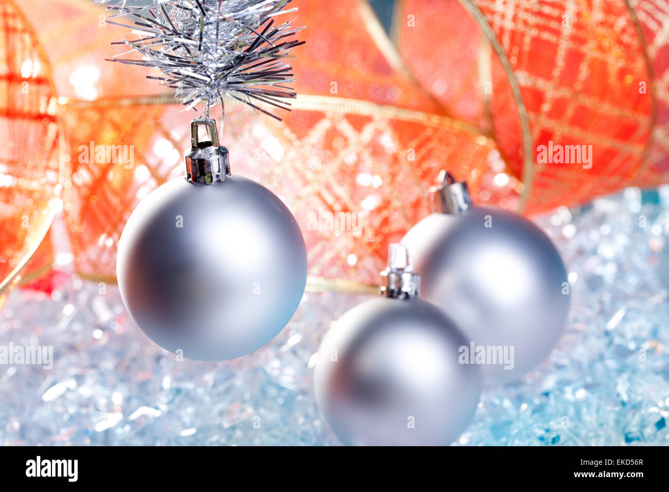 christmas silver baubles with red ribbon on ice Stock Photo - Alamy