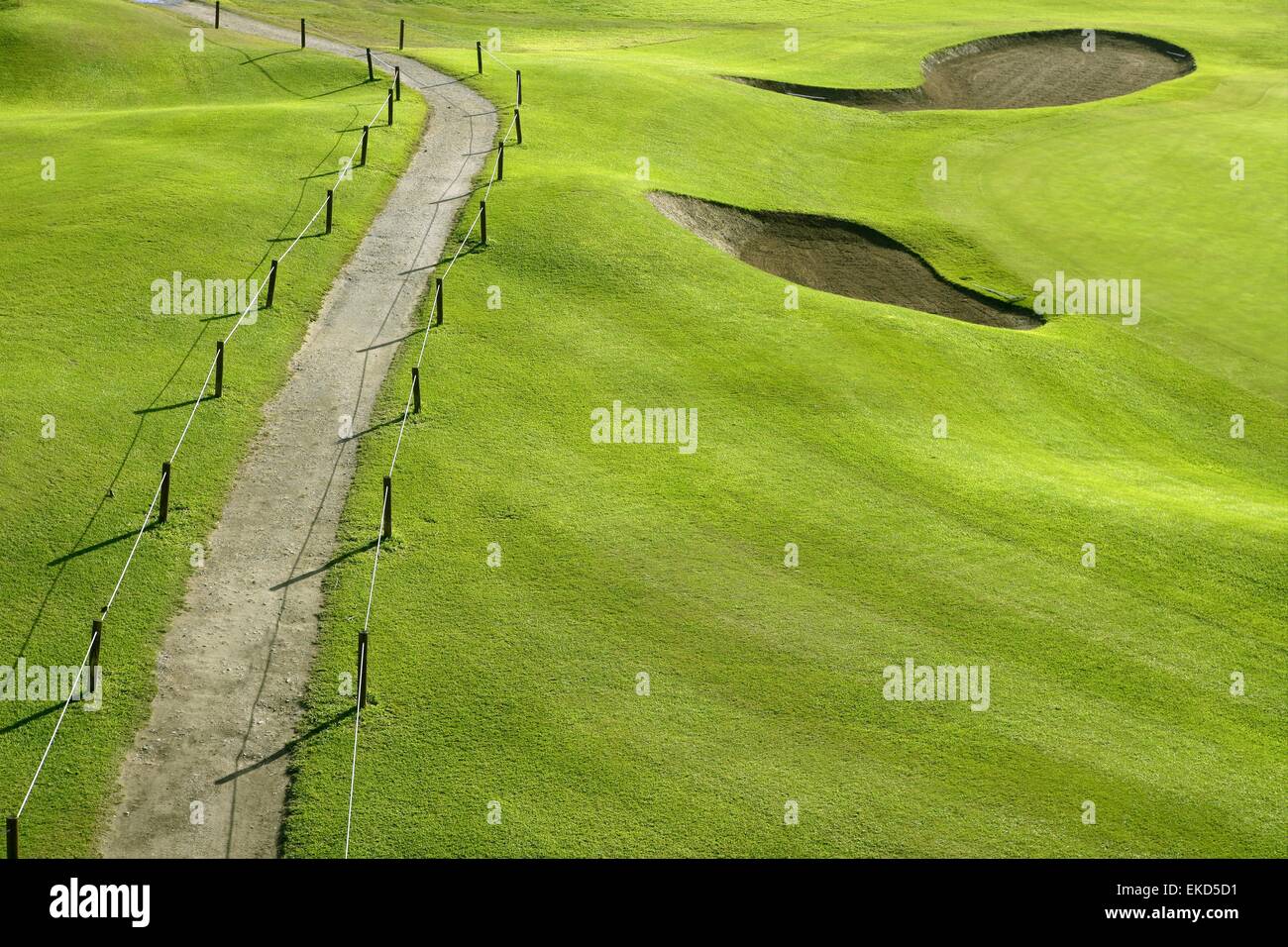 Golf course green grass hill field with holes Stock Photo - Alamy