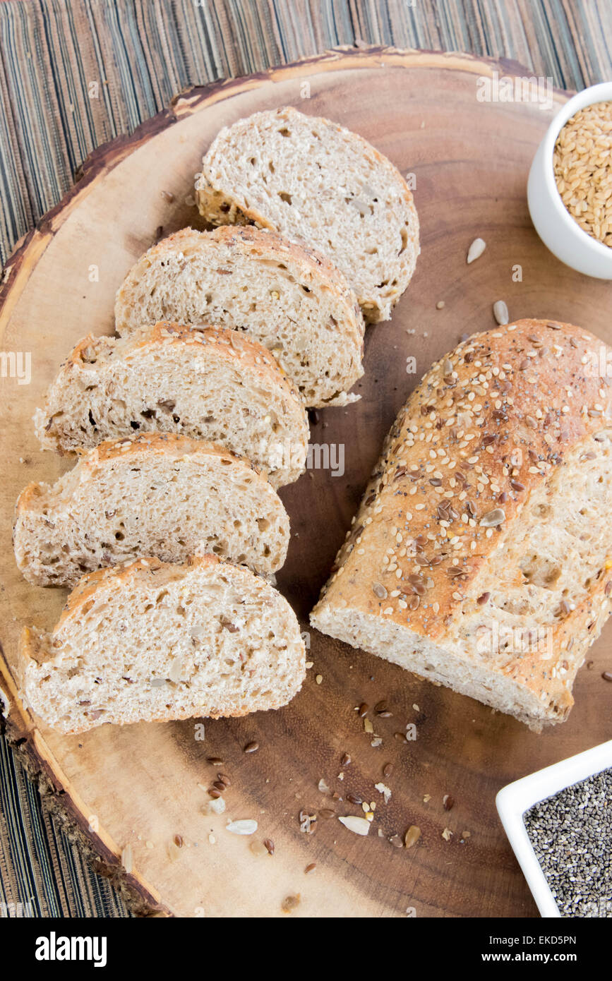 a fresh baked loaf of whole grains bread with poppy, flax and sunflower ...
