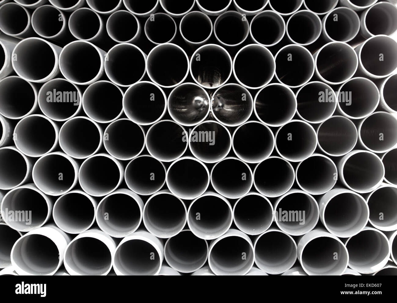 gray PVC tubes plastic pipes stacked in rows Stock Photo - Alamy
