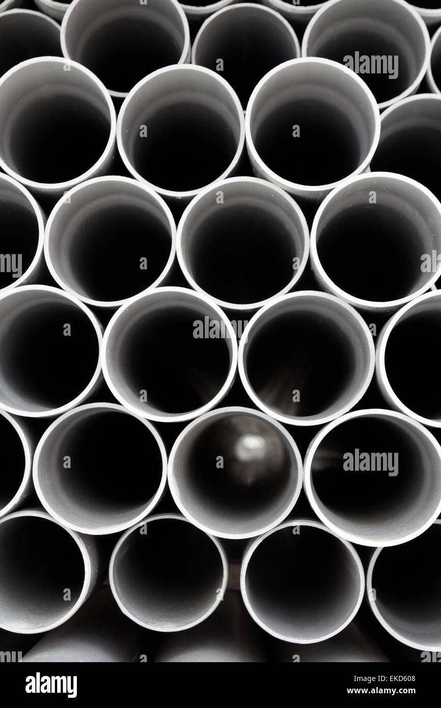gray PVC tubes plastic pipes stacked in rows Stock Photo - Alamy