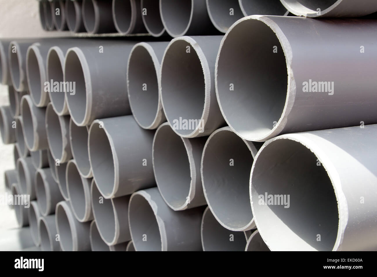 gray PVC tubes plastic pipes stacked in rows Stock Photo - Alamy