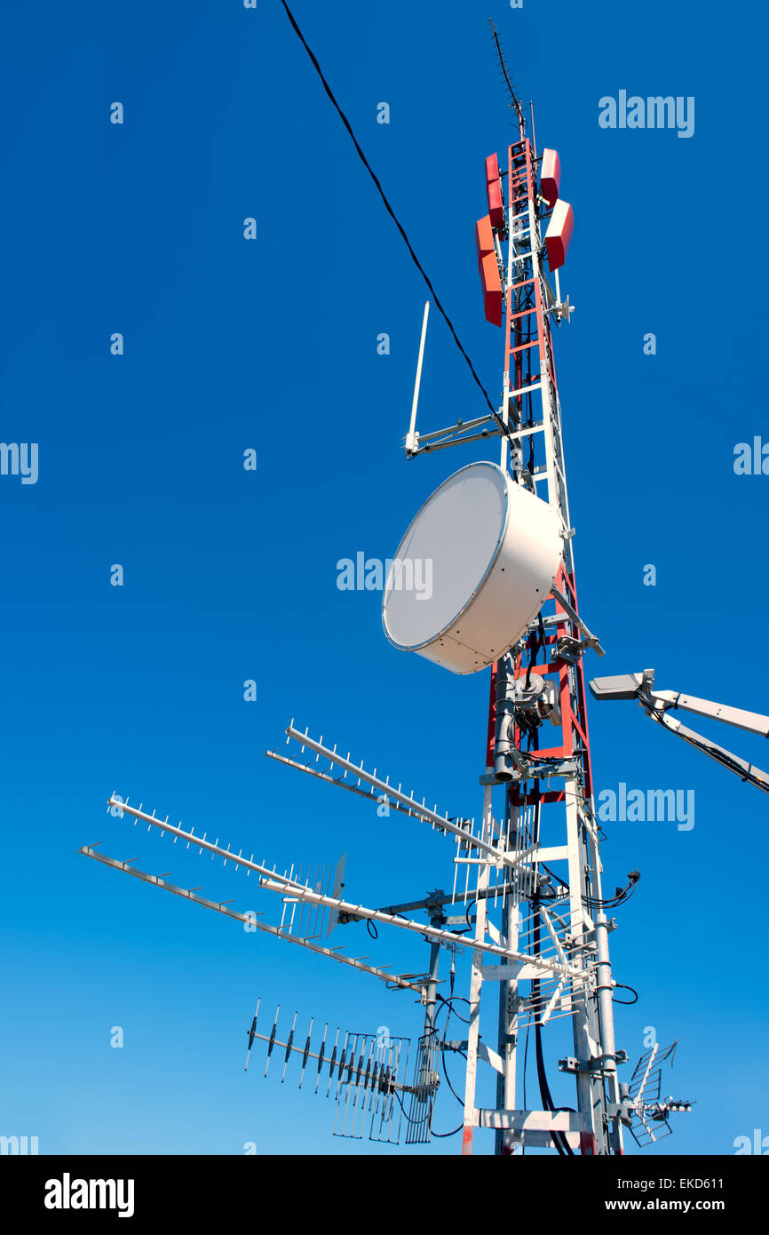 Antenna repeater messy mast in blue sky Stock Photo - Alamy