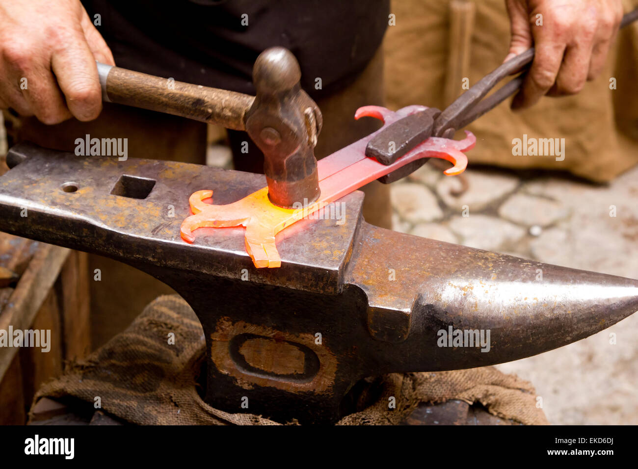 blacksmith forged iron smith anvil hammerman Stock Photo - Alamy