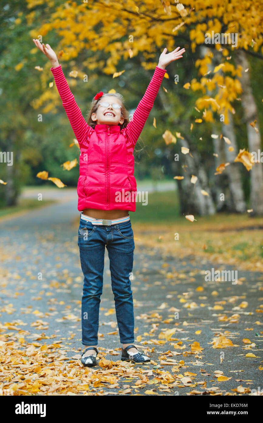 Cute girl walking in the autumn park Stock Photo - Alamy