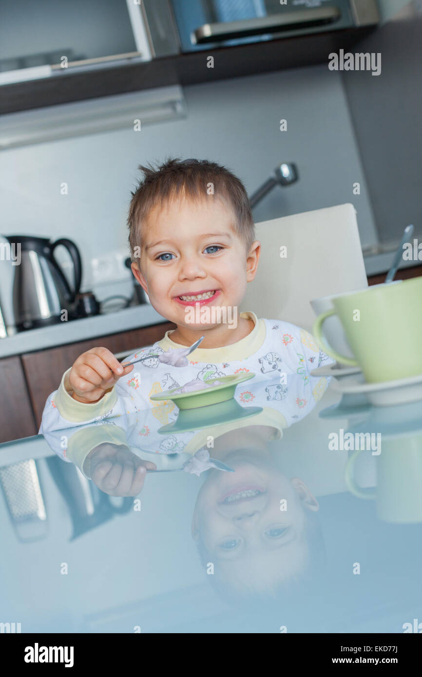 Happy Boy Eating Breakfast Stock Photo - Alamy