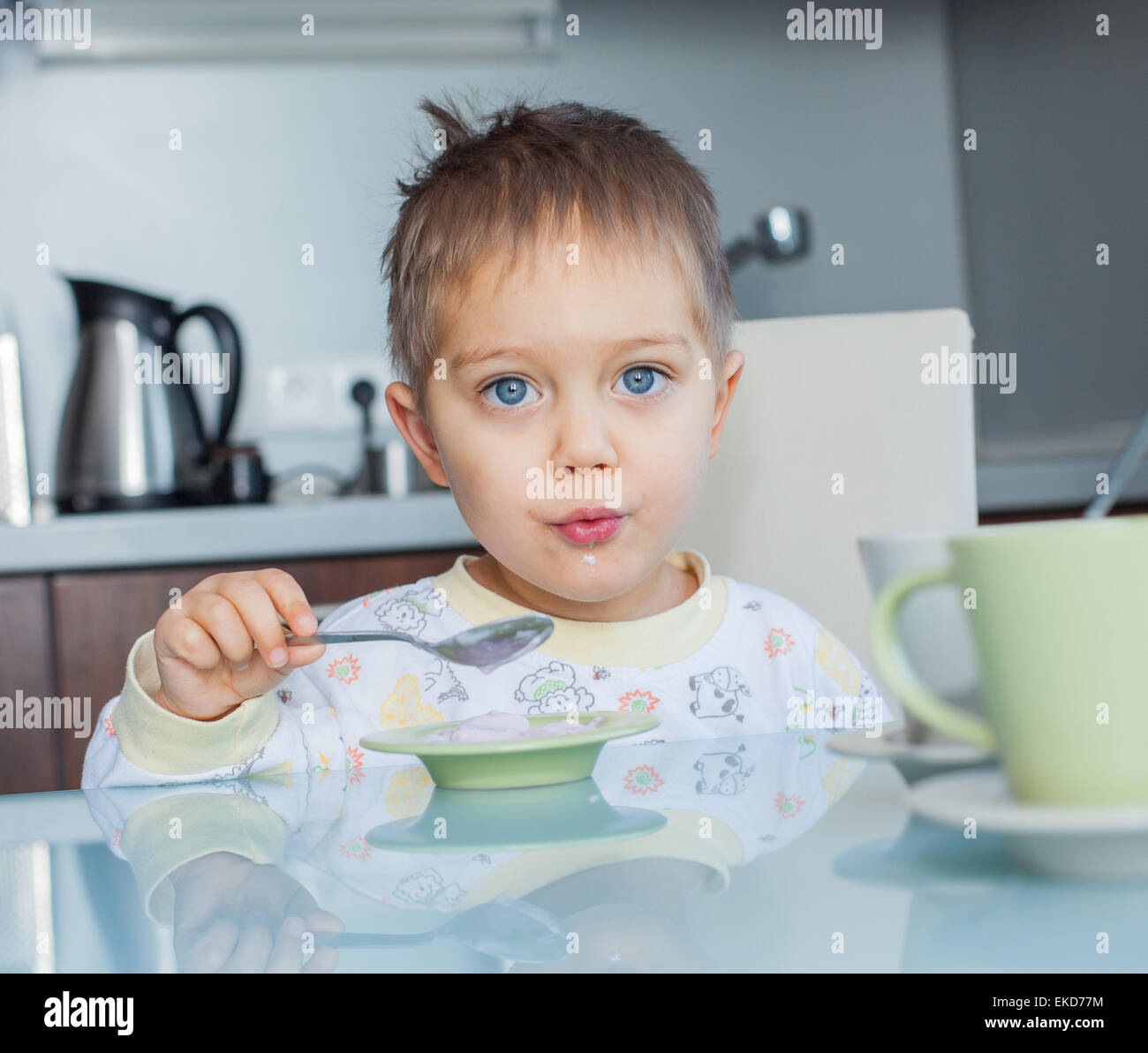 Happy Boy Eating Breakfast Stock Photo - Alamy