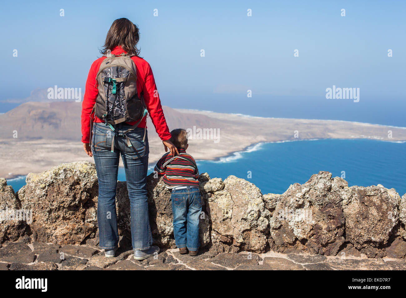 Back view mother and son standing on cliff's edge Stock Photo - Alamy