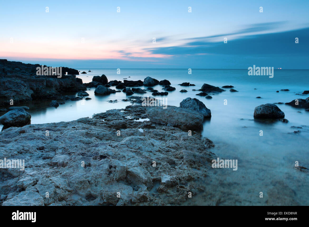 Beautiful rocky sea beach at the sunset Stock Photo - Alamy