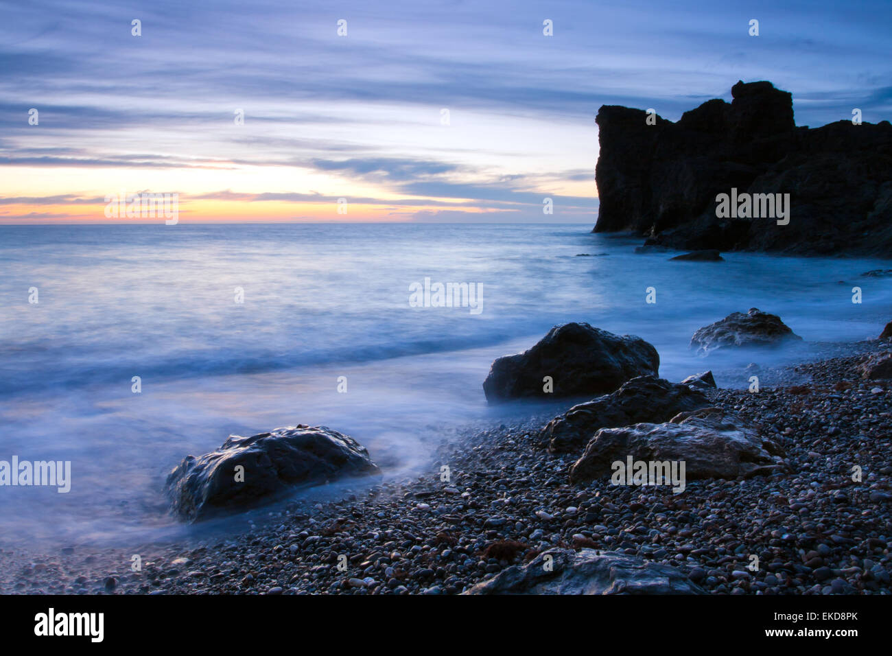 Beautiful rocky sea beach at the sunset Stock Photo - Alamy