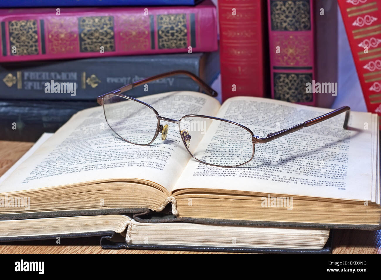 Vintage books with glasses on wooden table Stock Photo - Alamy