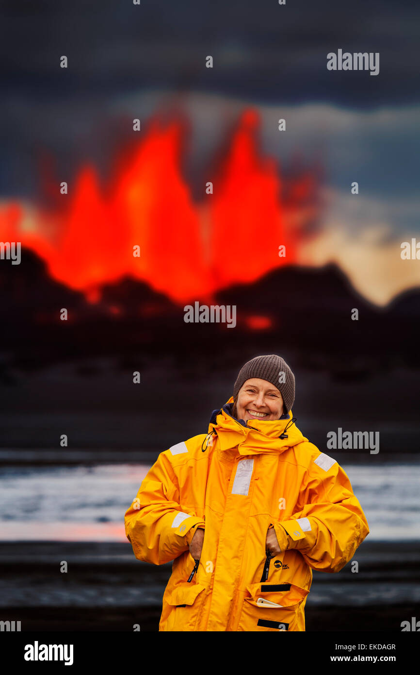 Woman standing by Glowing lava from the eruption at the Holuhraun ...