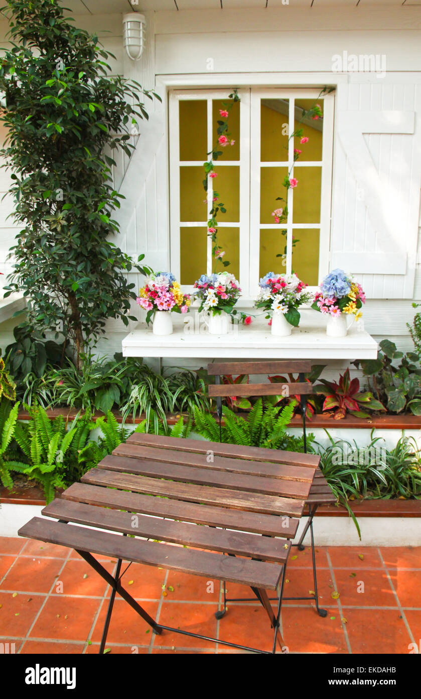 Decorated flowers on window with table and chair in garden Stock Photo ...