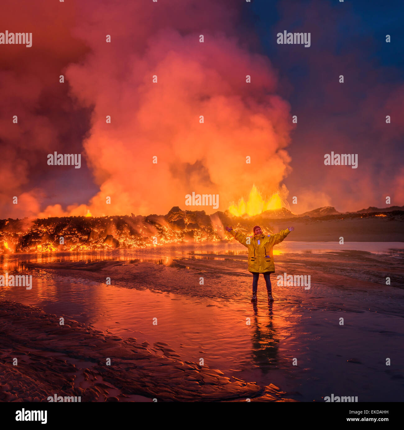 Woman standing by Glowing lava from the eruption at the Holuhraun ...