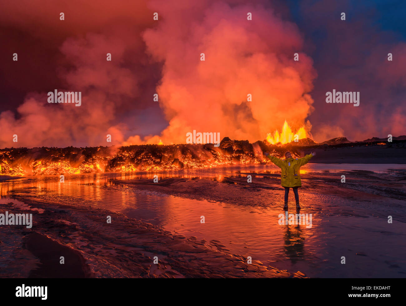 Woman standing by Glowing lava from the eruption at the Holuhraun ...