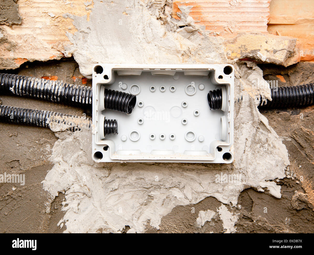 electrical coil conduit pipe on box embedded in wall Stock Photo - Alamy