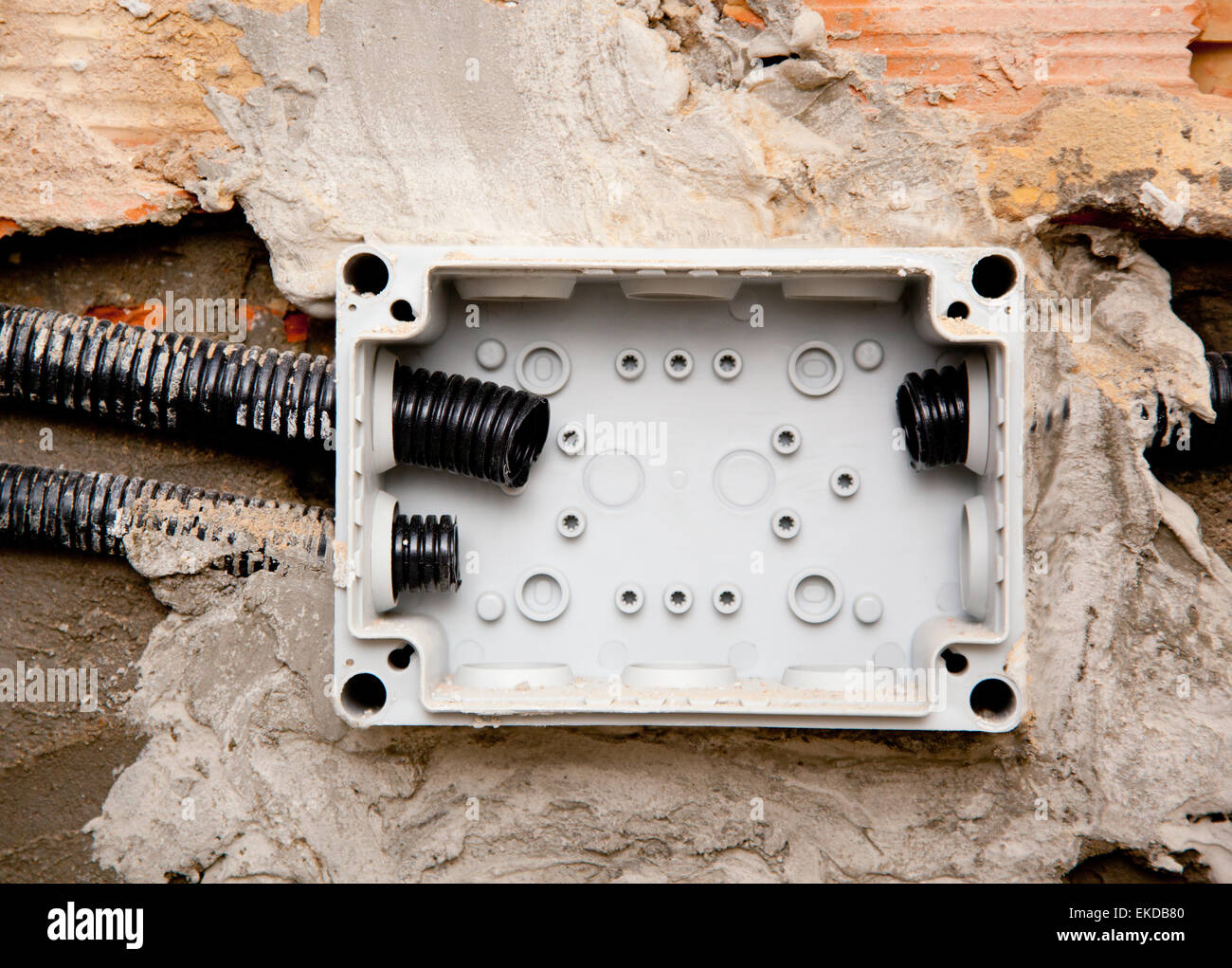electrical coil conduit pipe on box embedded in wall Stock Photo - Alamy