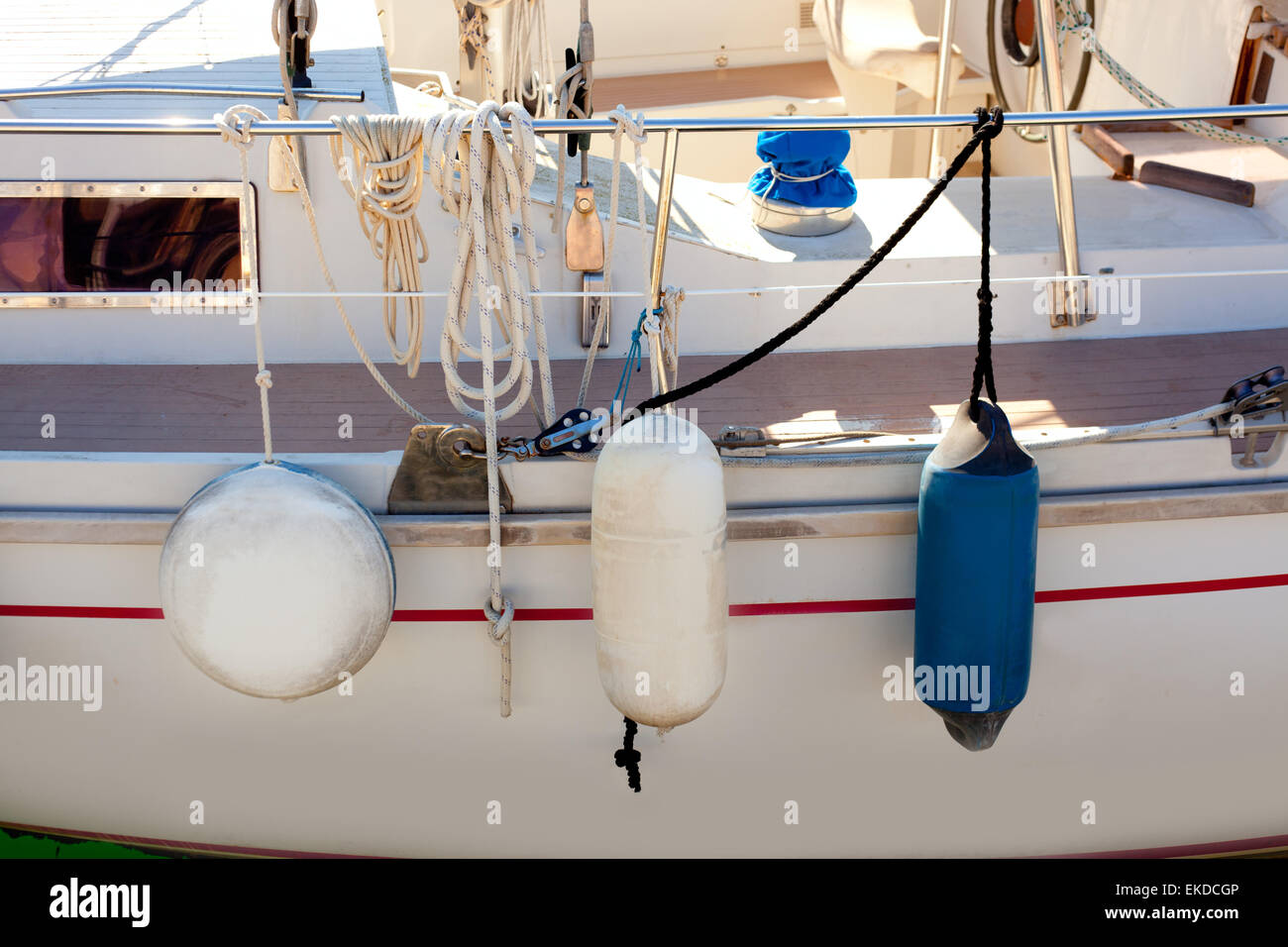 fender buoys on sailboat side with ropes Stock Photo - Alamy