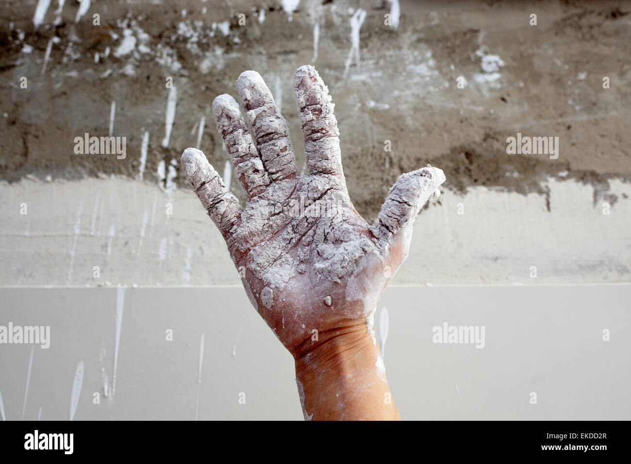Astist plastering man hand with cracked plaster Stock Photo - Alamy