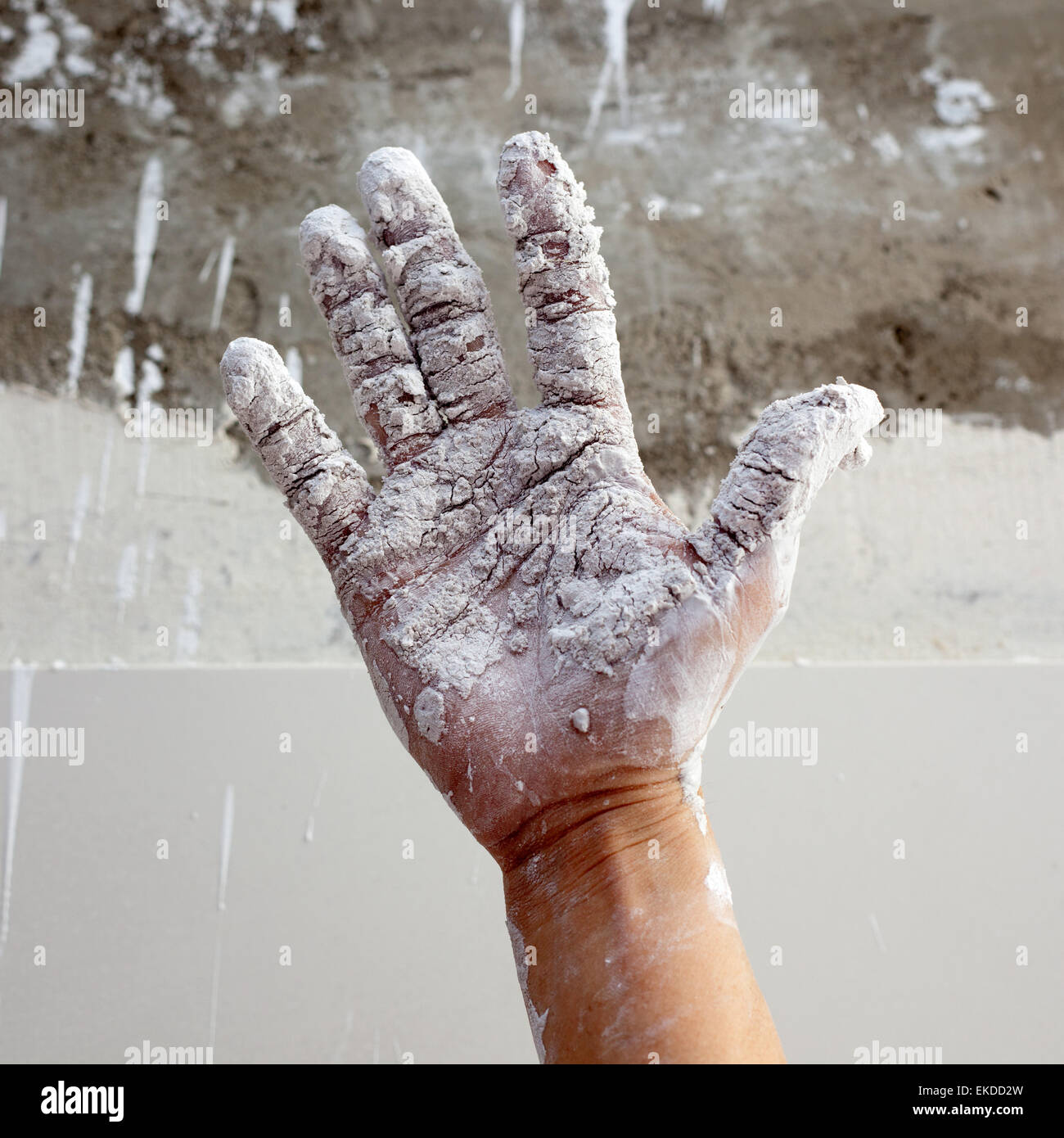Astist plastering man hand with cracked plaster Stock Photo - Alamy