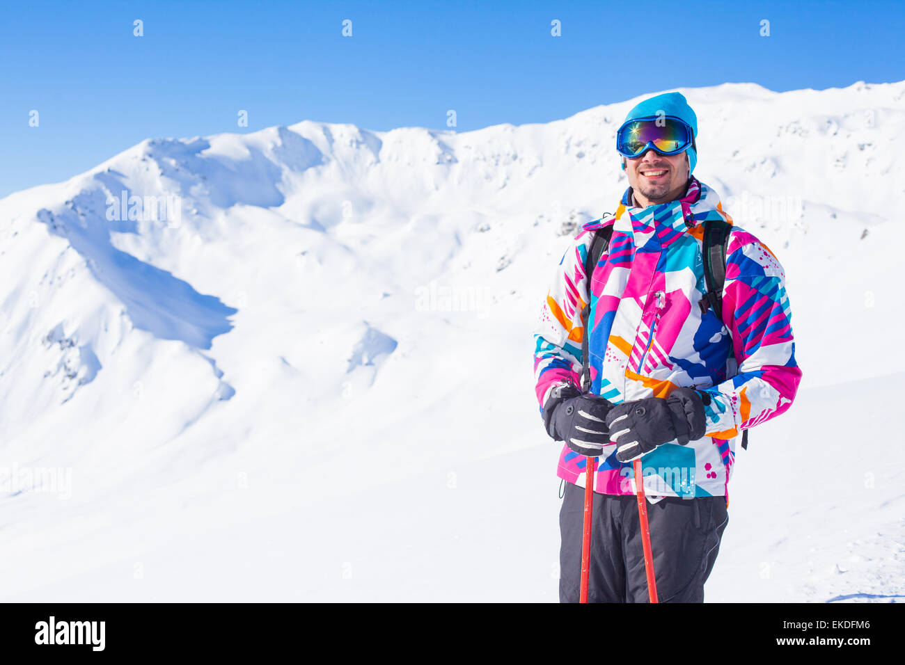 Young man with skis and a ski wear Stock Photo - Alamy